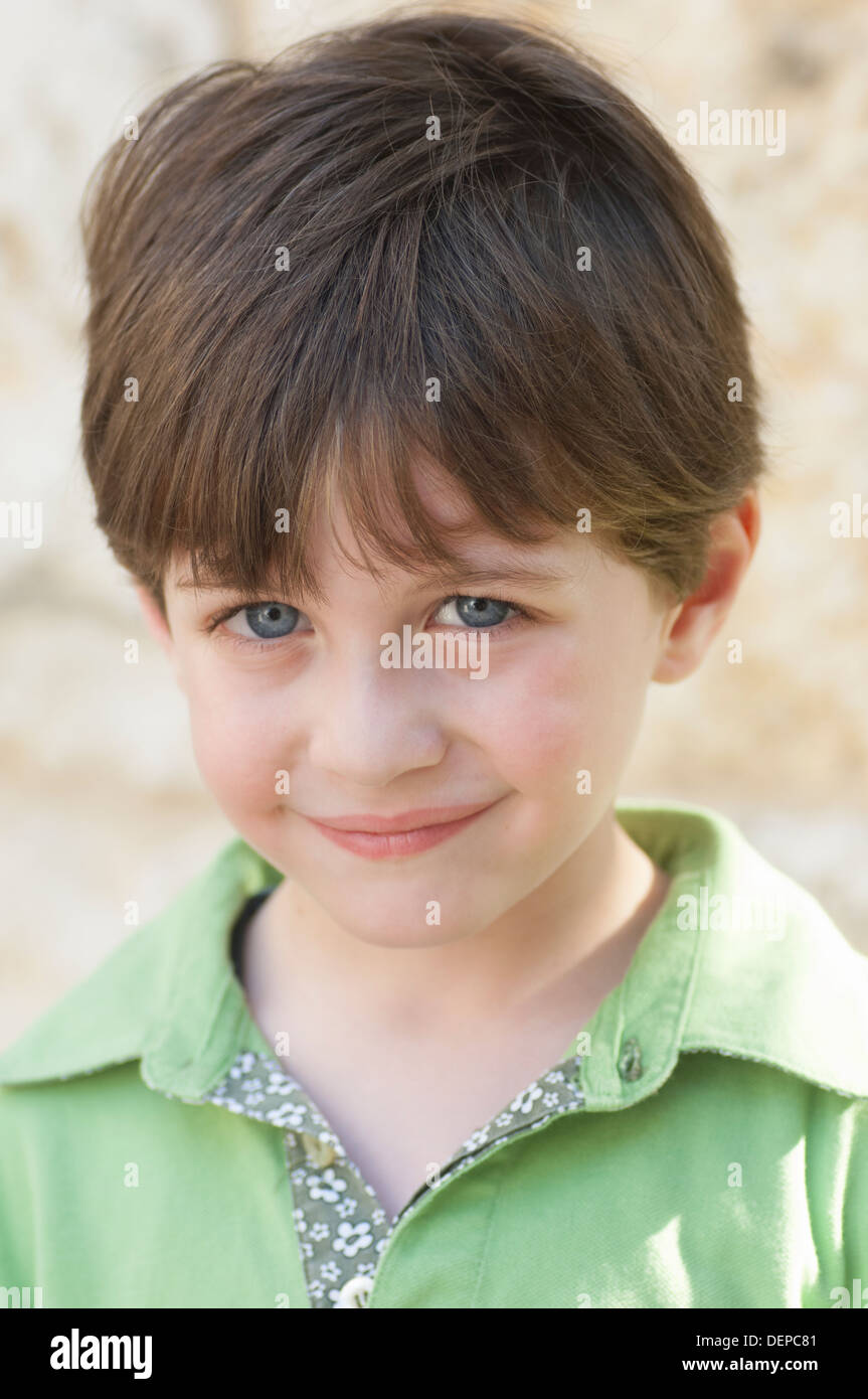 Shy little boy smiling Stock Photo - Alamy