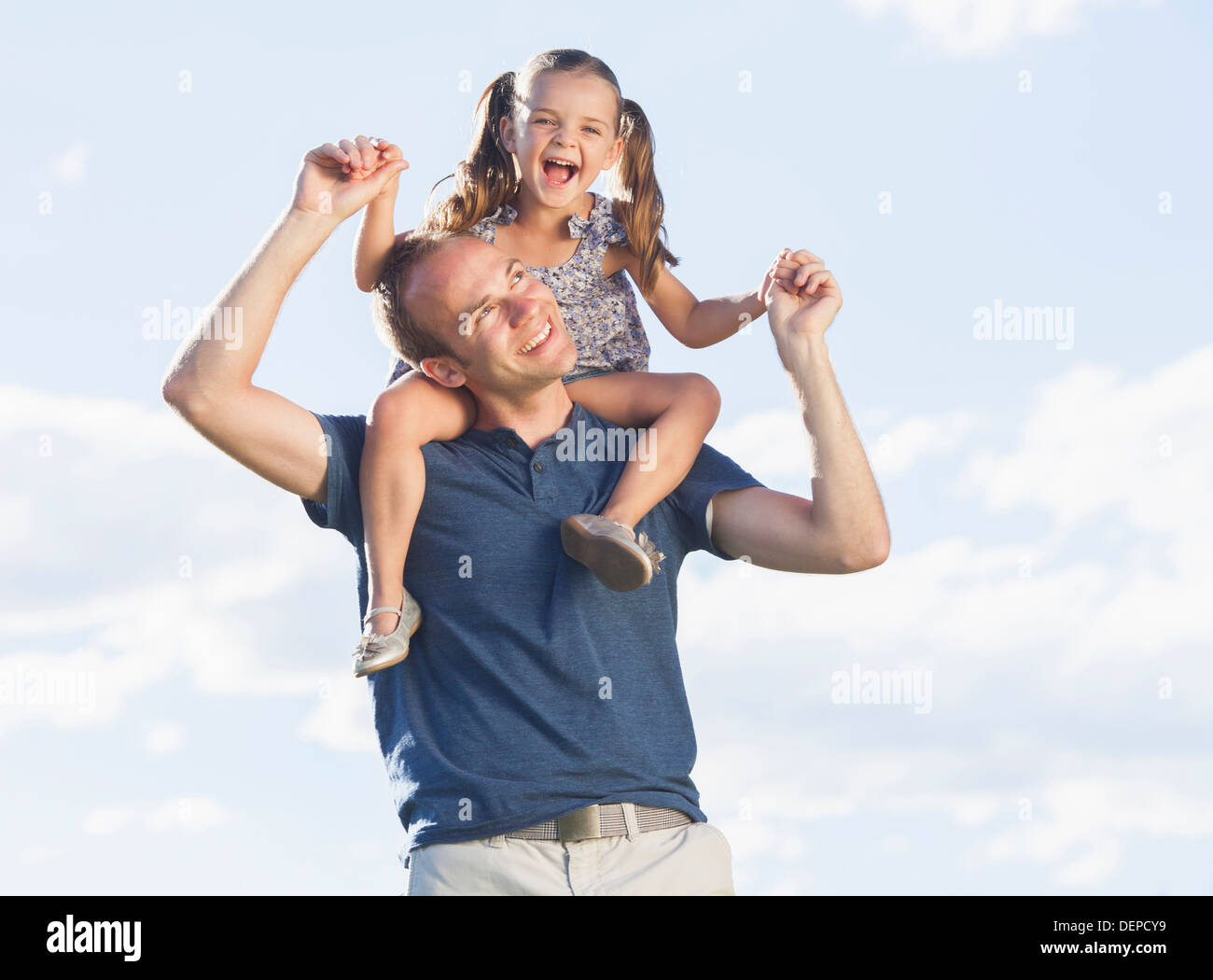 Caucasian father carrying daughter on shoulders Stock Photo - Alamy