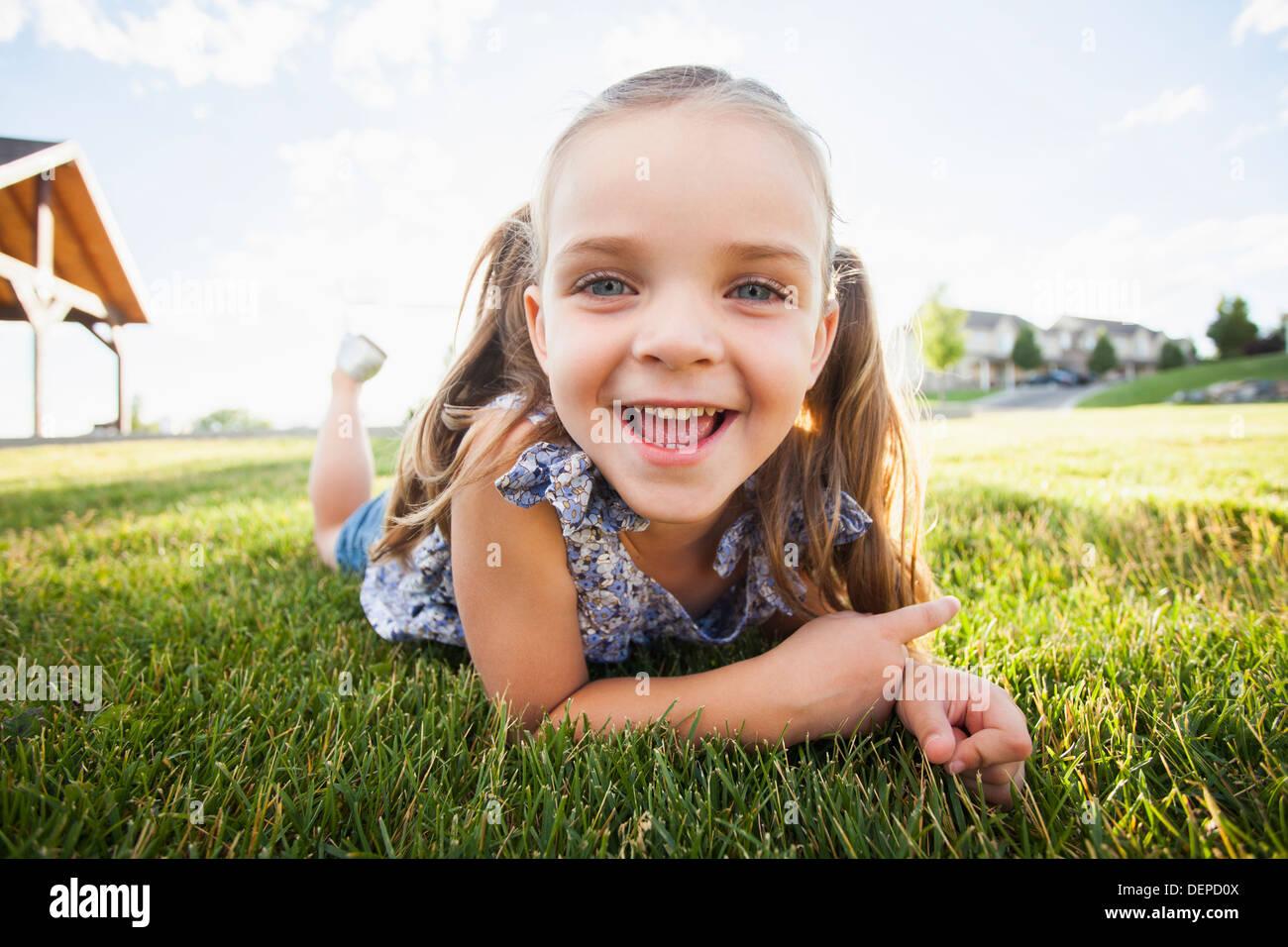 Caucasian girl laying in grass Stock Photo - Alamy