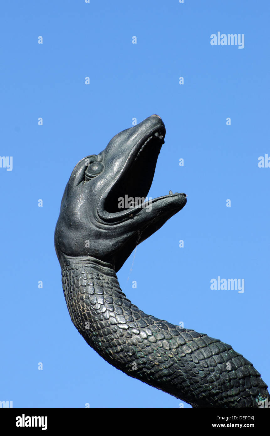 portrait shot of a metallic looking snakes head and neck with jaws open ...