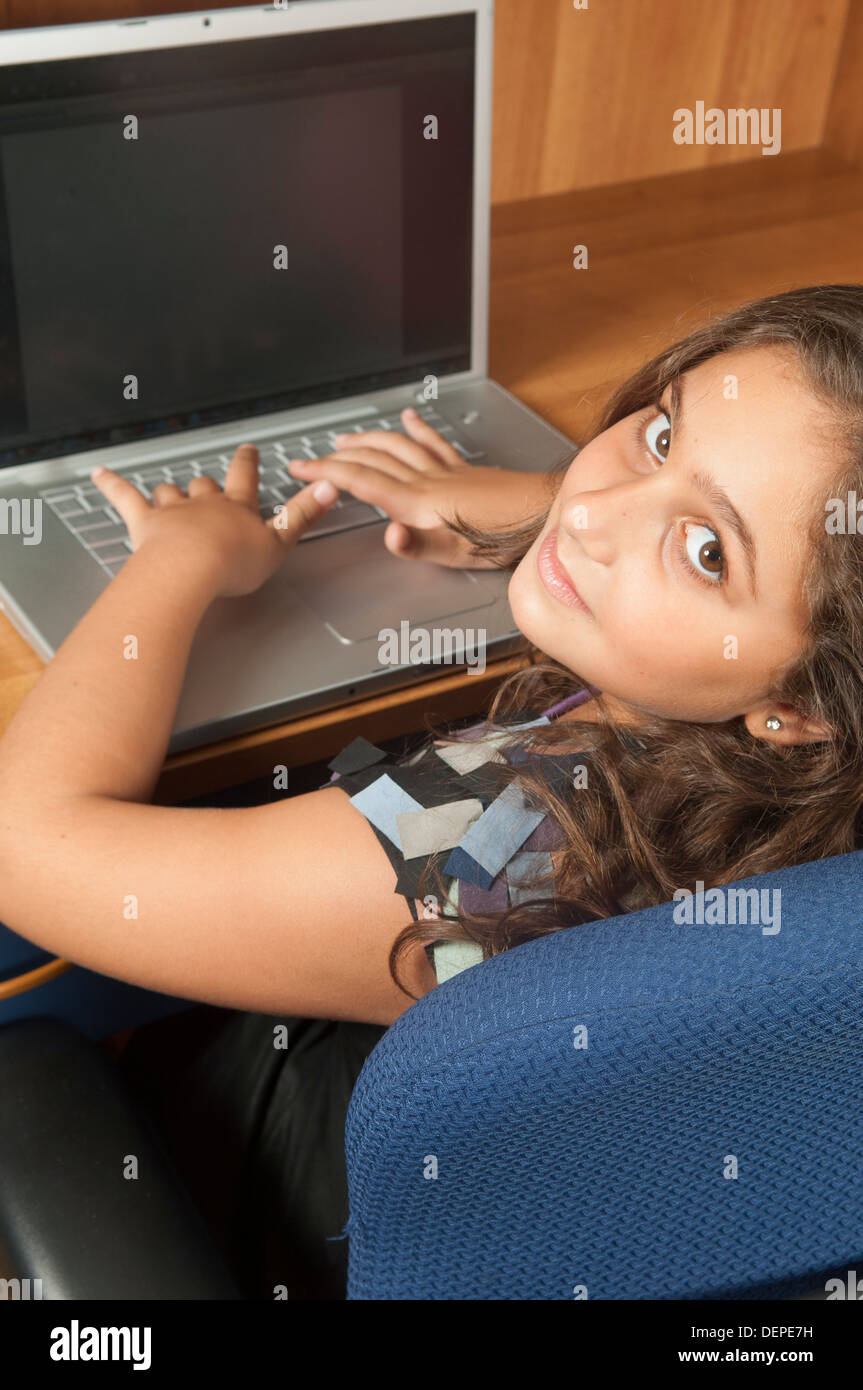 Girl typing on laptop looking up Stock Photo - Alamy
