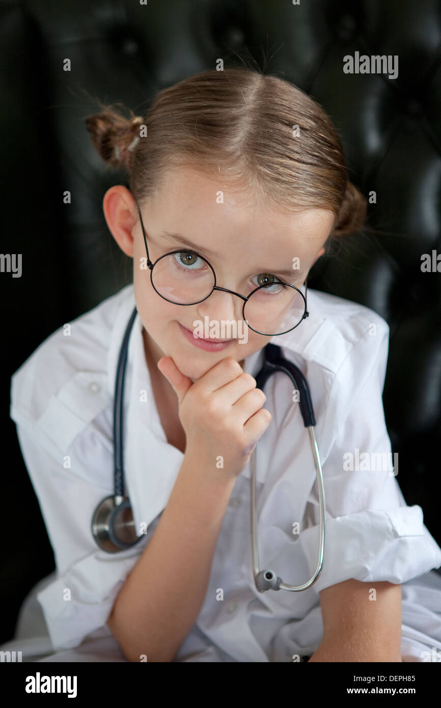Young white girl with stethoscope pretending to be a doctor and ...