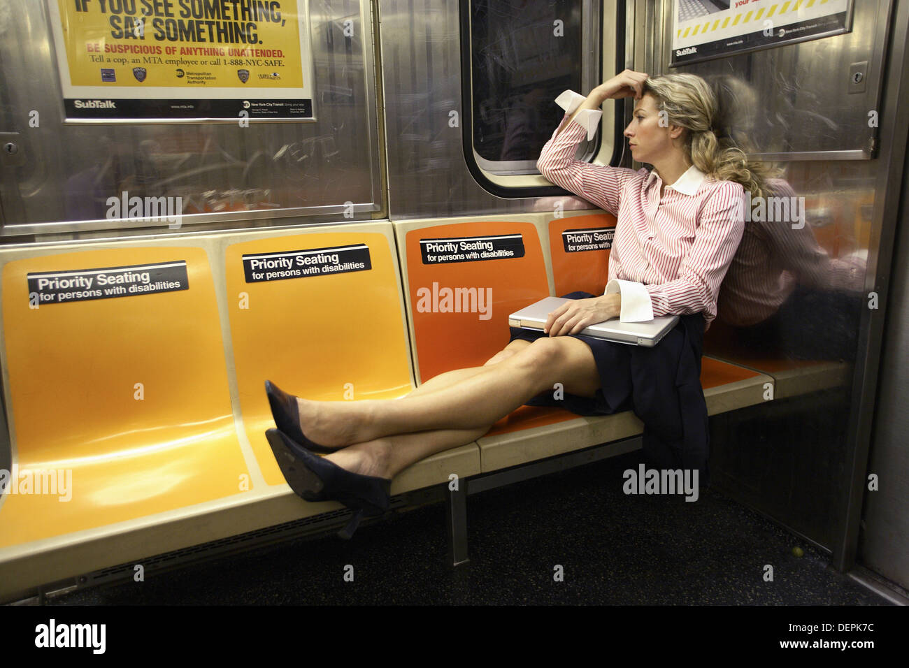 Woman subway computer not smiling hi-res stock photography and images ...