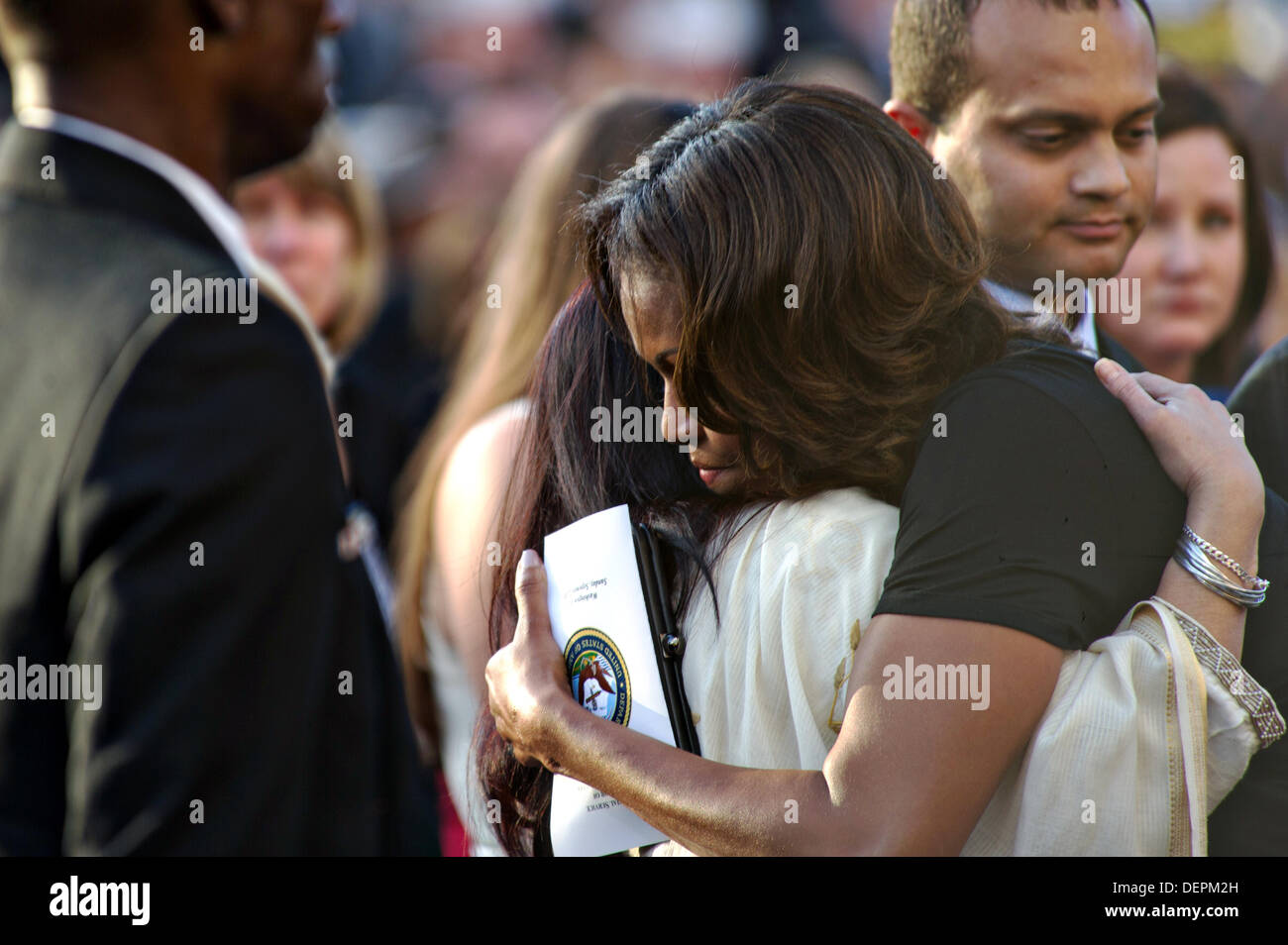 US First Lady Michelle Obama hugs family members during a memorial at ...