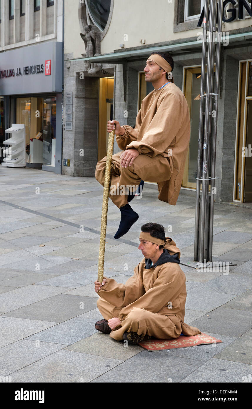 street artists performing an illusion in the square in front of cologne ...