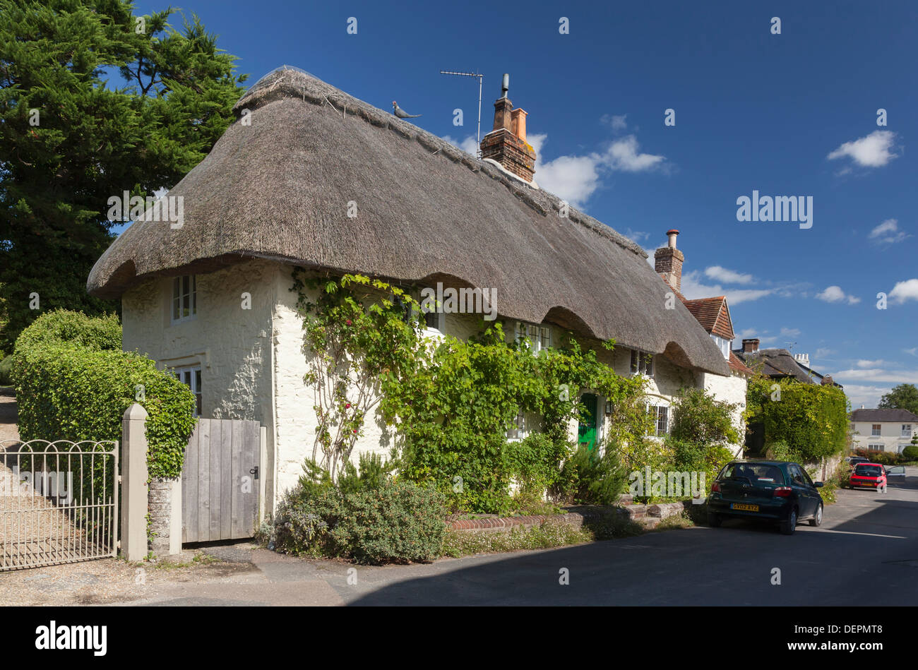 A traditional thatched cottage in the village of Amberley in West ...