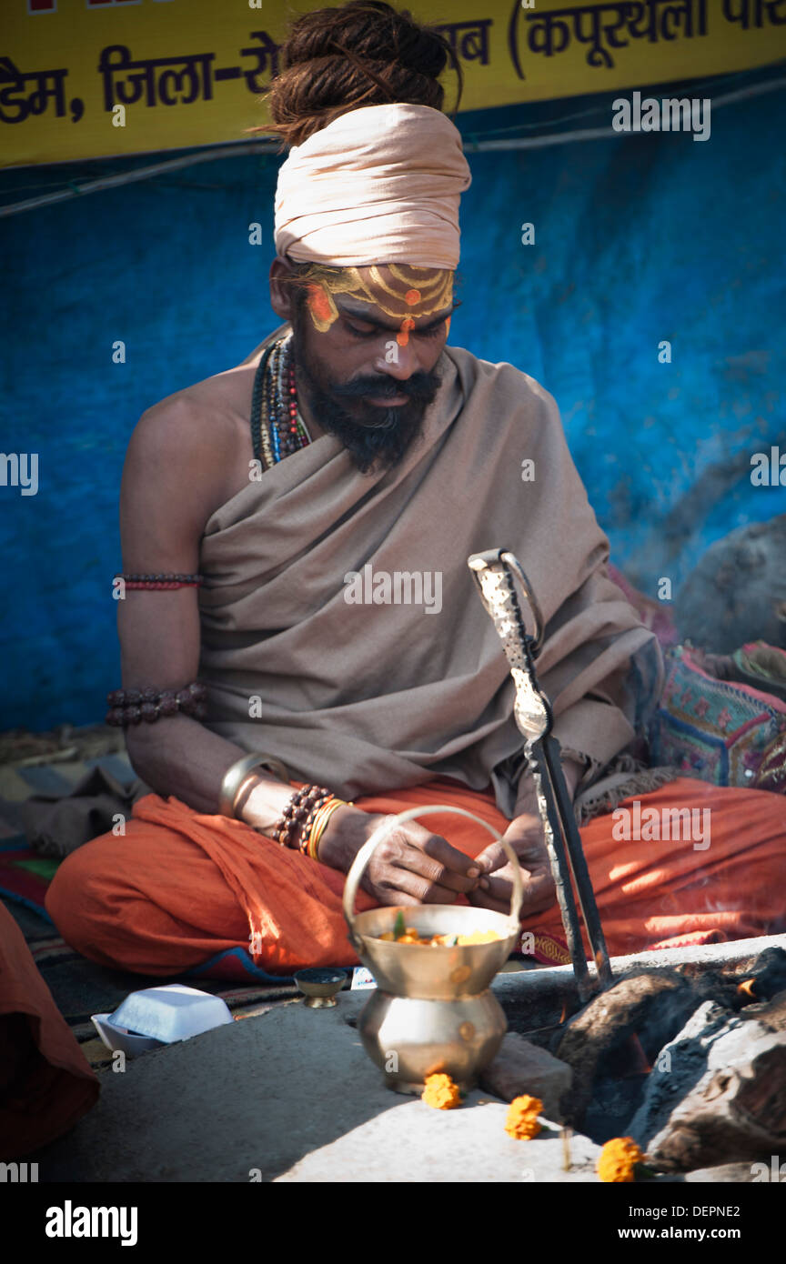 Hindu sadhu sitting in front of Hawan Kund at Maha kumbh, Allahabad ...