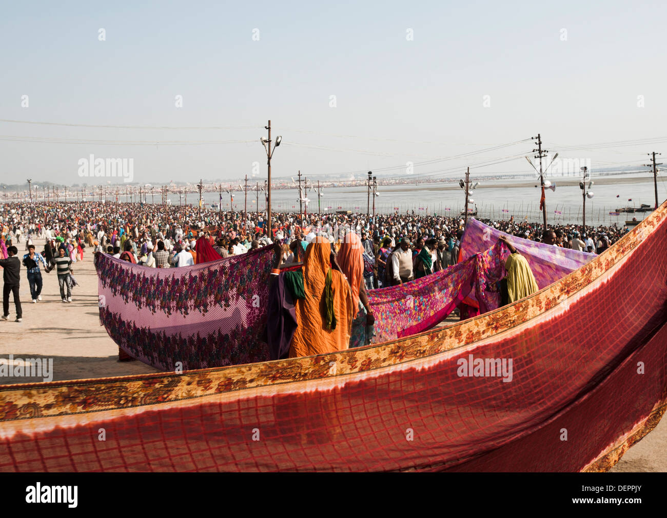 Crowd of pilgrims on the bank of Ganges River at a holy bath at Maha ...