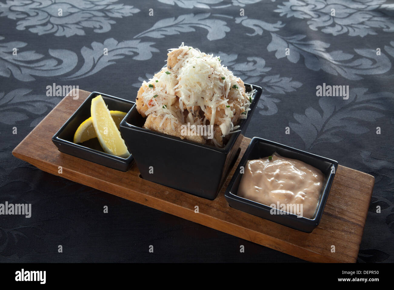 Chicken meat with potatoes and cheese cooked in clay pot in the oven ...