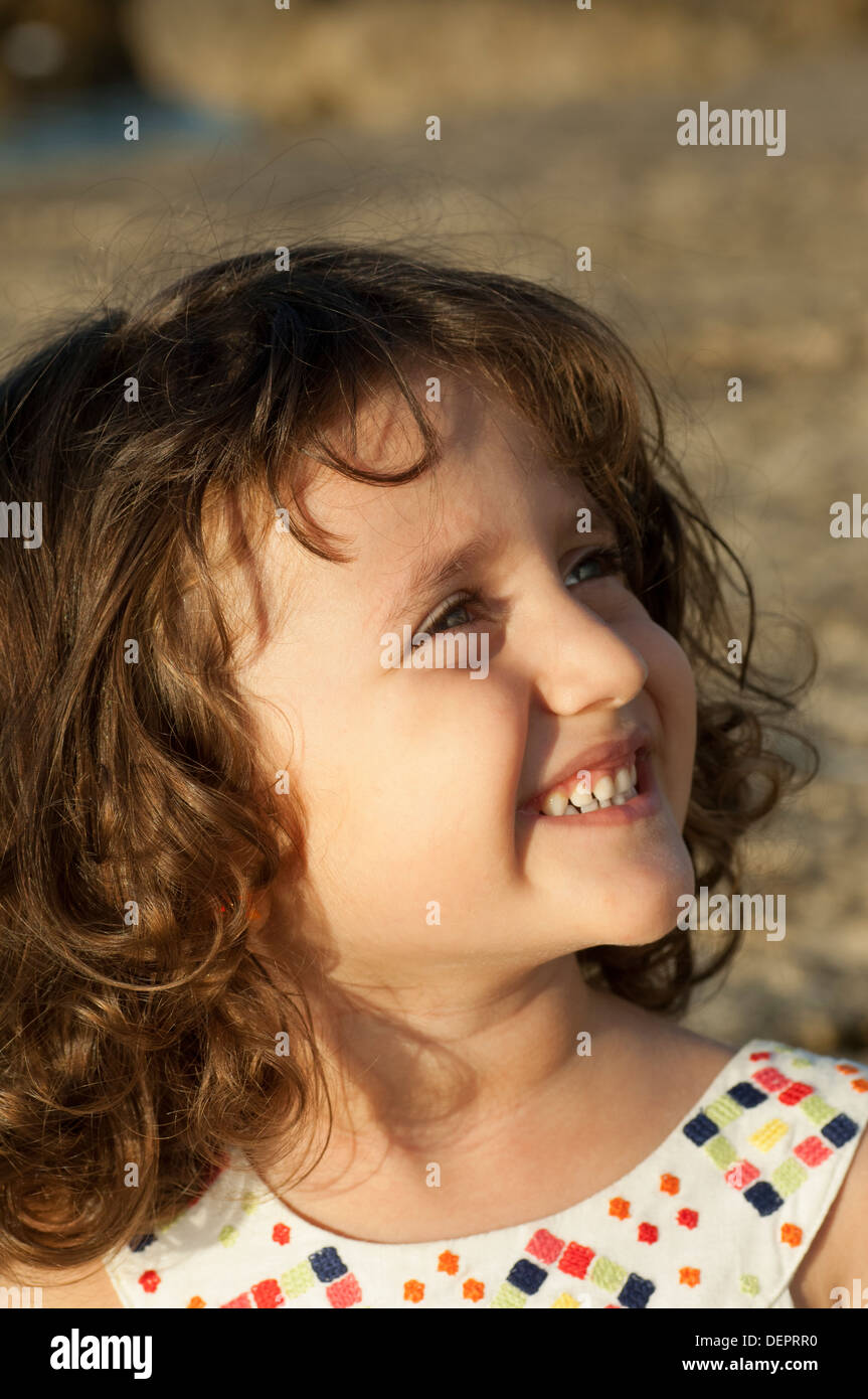 Happy girl looking up smiling Stock Photo - Alamy