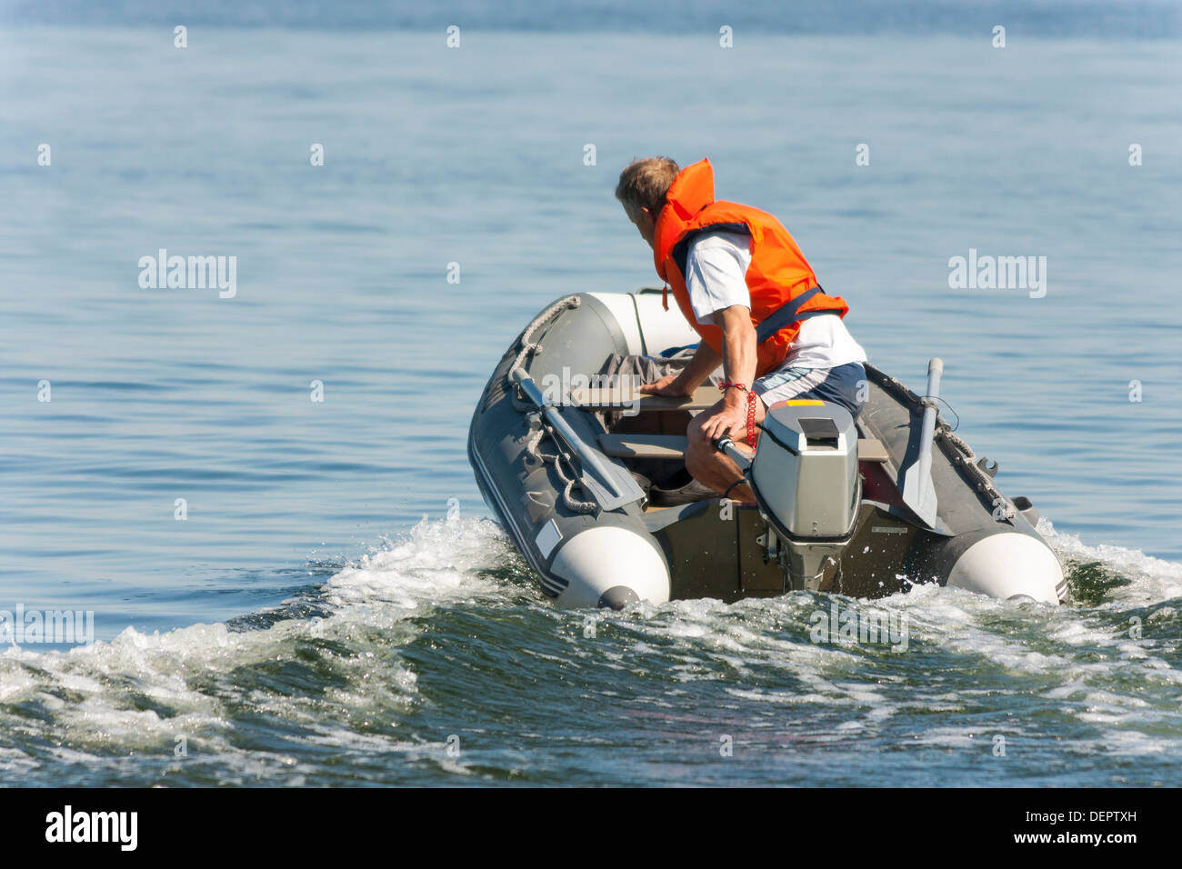 Man driving on a boat Stock Photo - Alamy