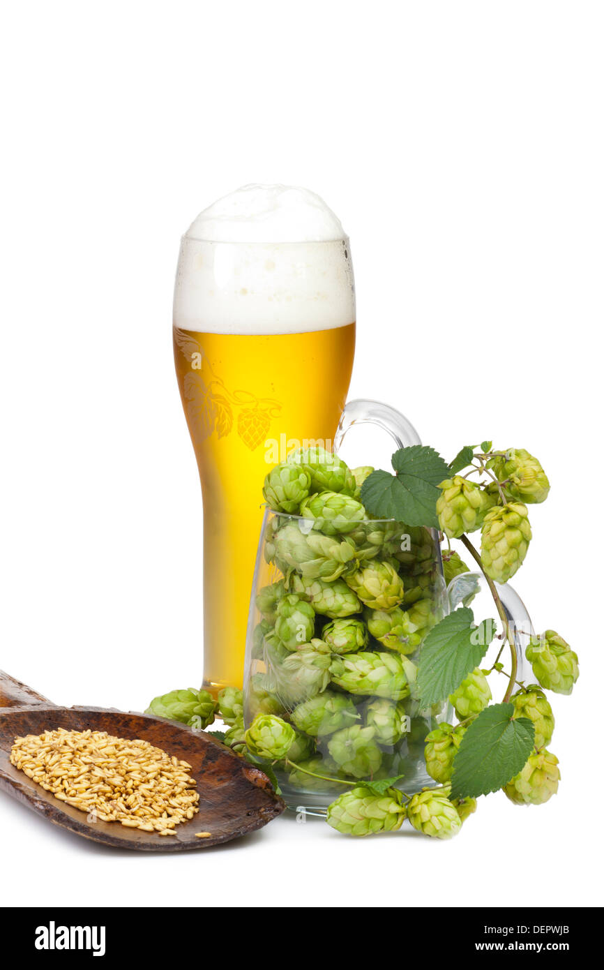 Glass of fresh beer with hops and barley on an old wooden shovel ...