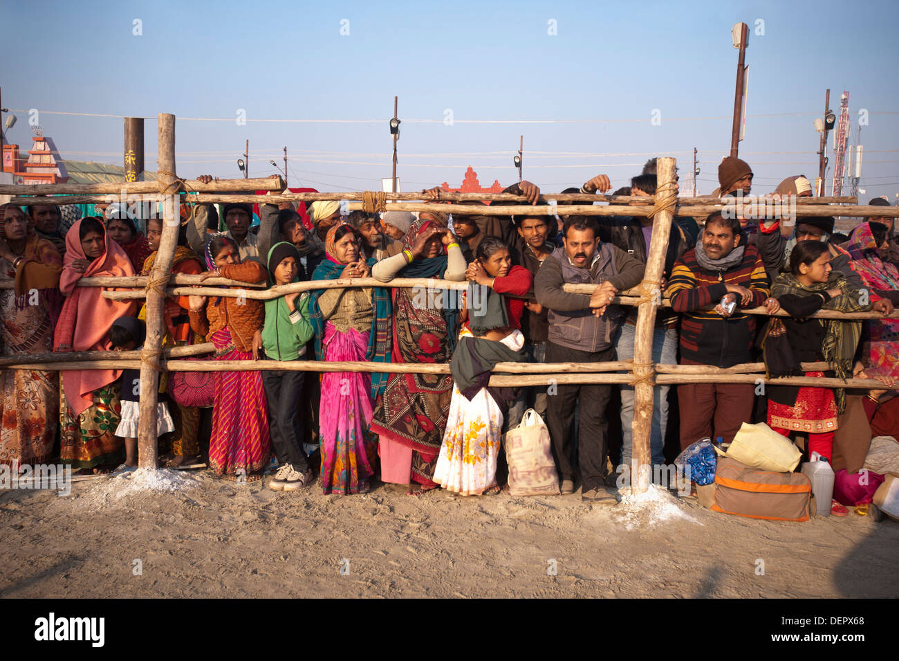 Crowd standing behind fence watching hi-res stock photography and ...