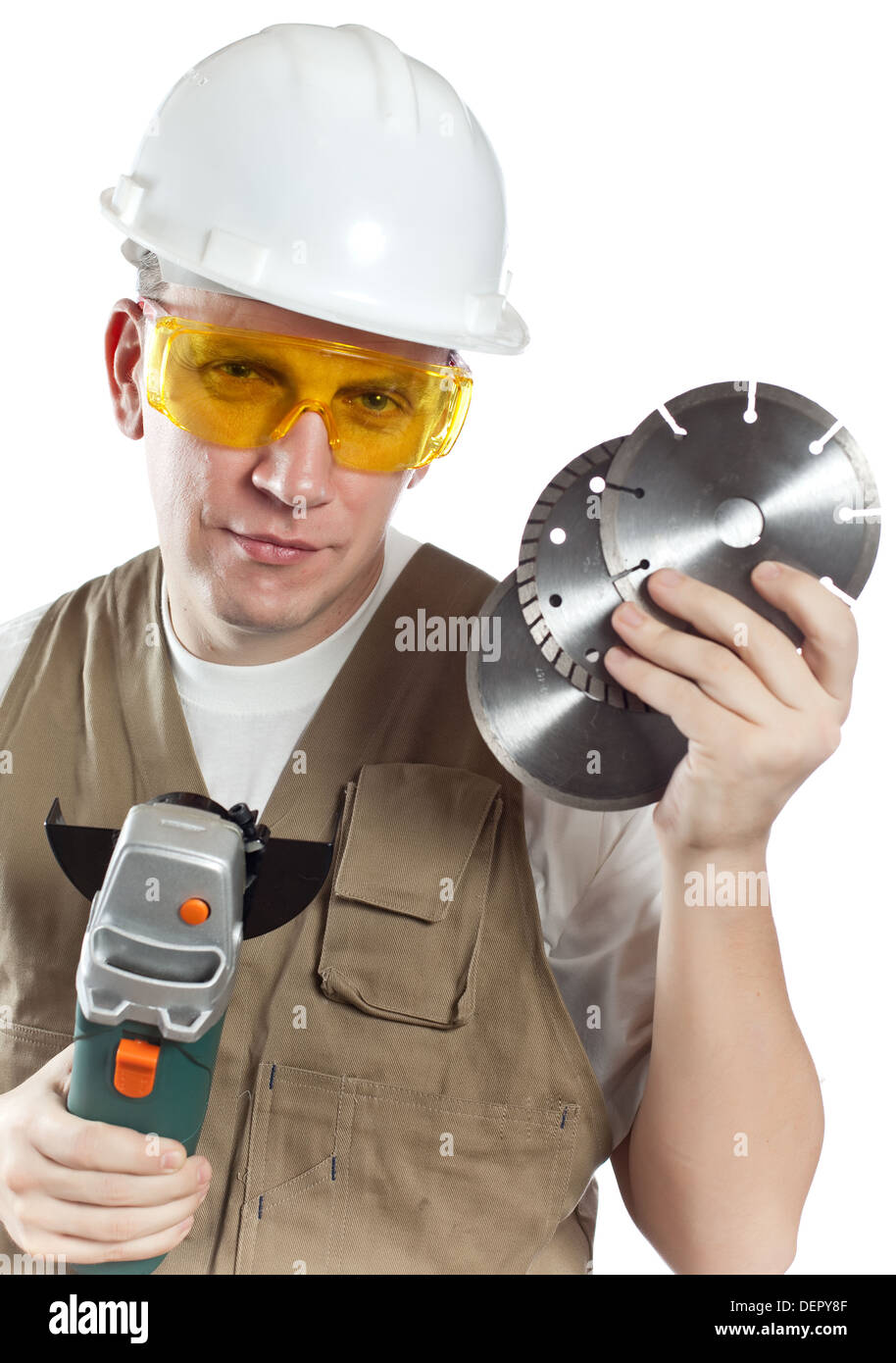 The man in working overalls with the detachable machine and saw disks ...