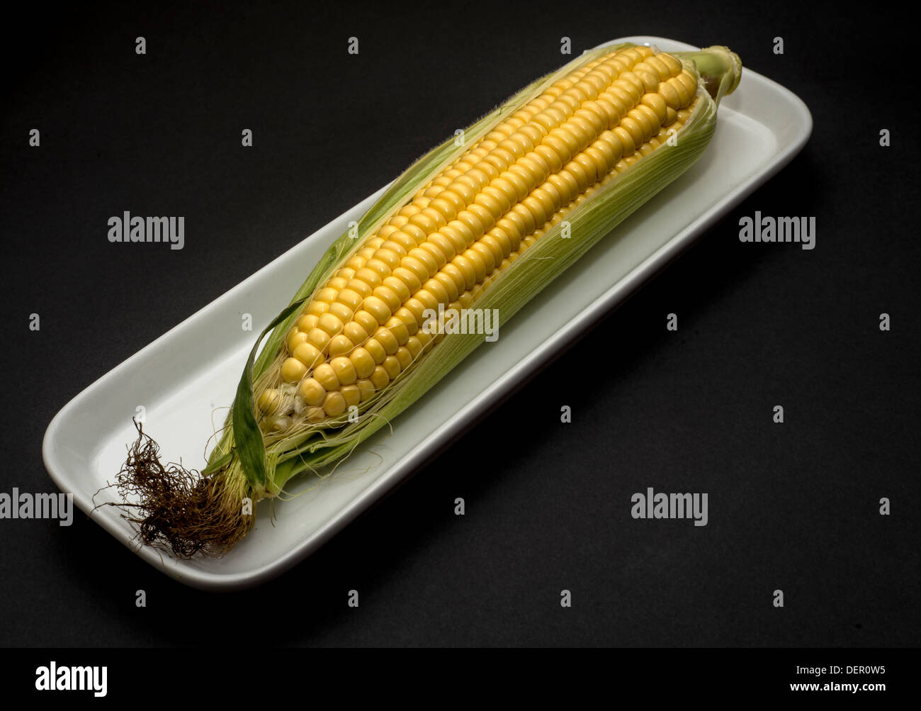 sweet con in a white dish on black background Stock Photo - Alamy