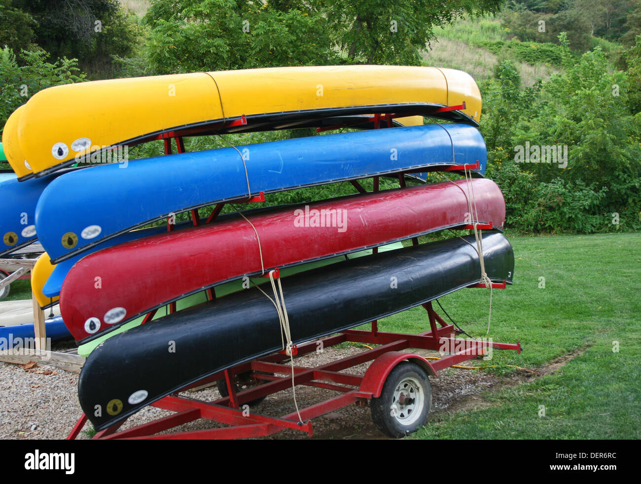 Four colorful canoes on a canoe trailer Stock Photo - Alamy