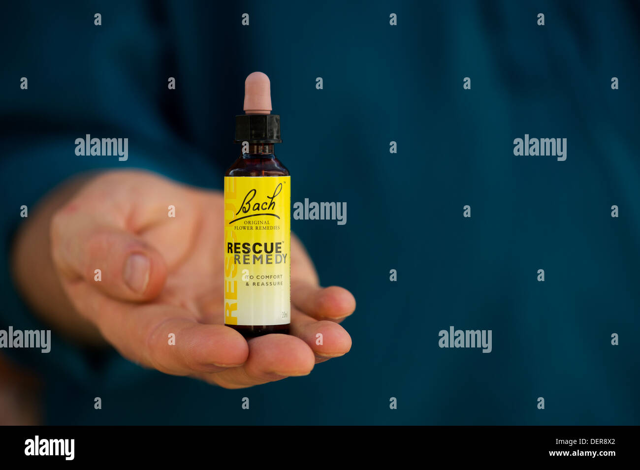 Hand holding a bottle of Bach flower essence. Rescue Remedy Stock Photo ...