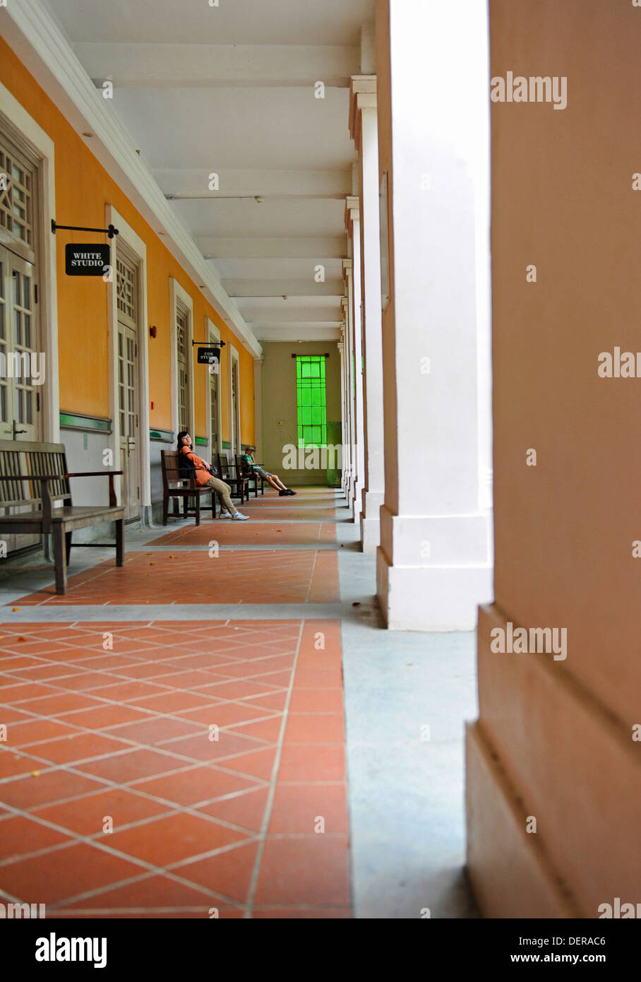 Tired man and woman resting on the rear ground floor corridor seating ...