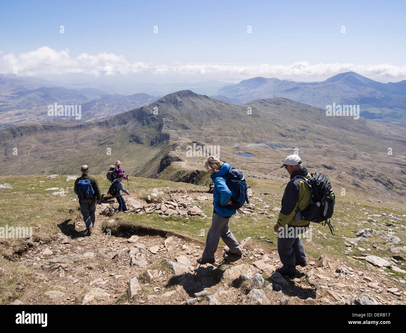 Ramblers walking down on south ridge path from Mount Snowdon with view ...