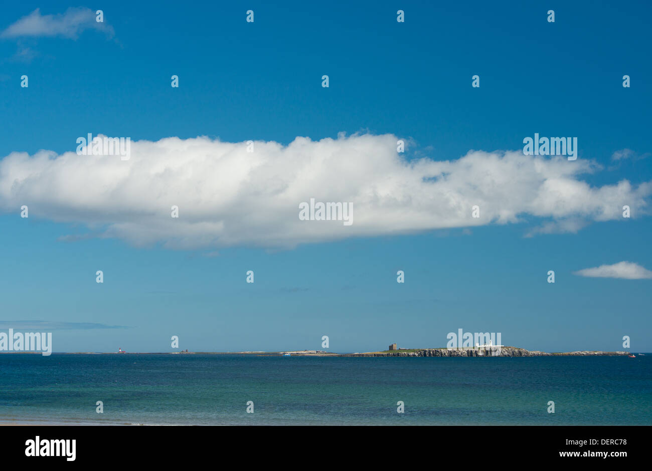 A view of the Inner Farne Island Lighthouse from the beach at Bamburgh ...