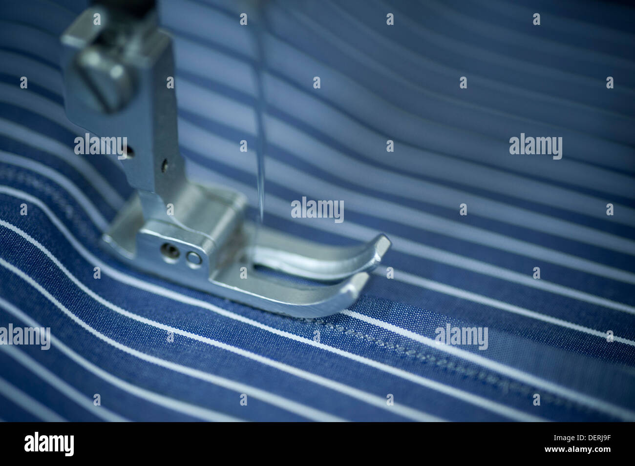 Cloth being stitched on the sewing machine Stock Photo - Alamy