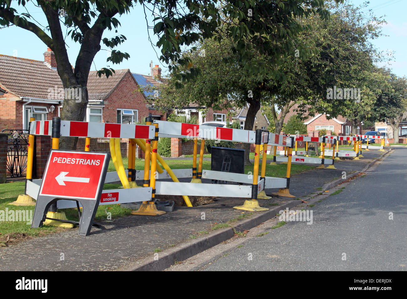 Road work warning signs and barriers in a street in England Stock Photo ...