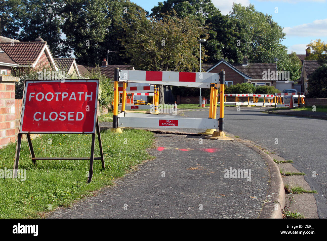 Road work warning signs and barriers in a street in England Stock Photo ...