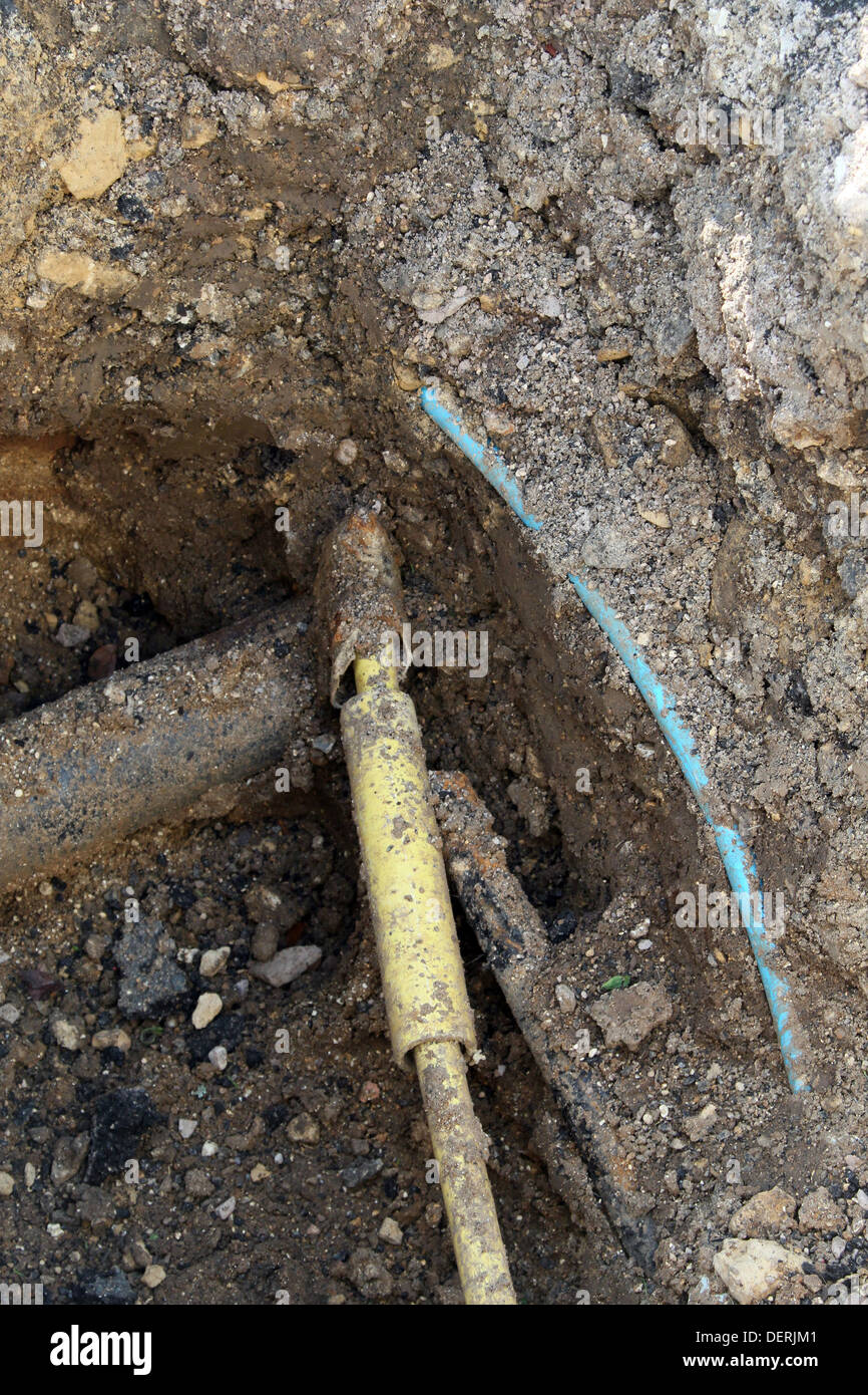 Underground pipe work undergoing repair in a street in England Stock ...