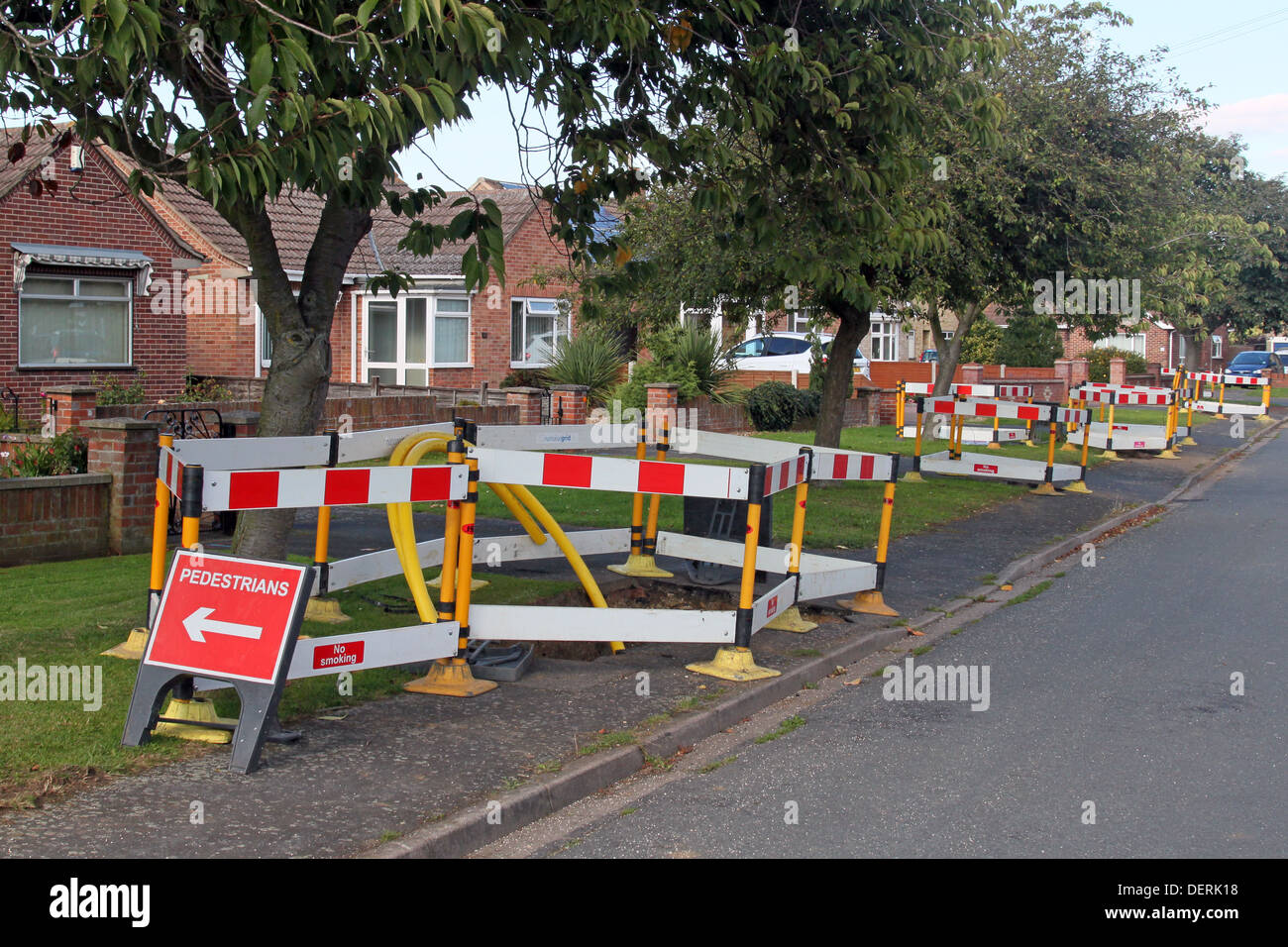 Road work warning signs and barriers in a street in England Stock Photo ...