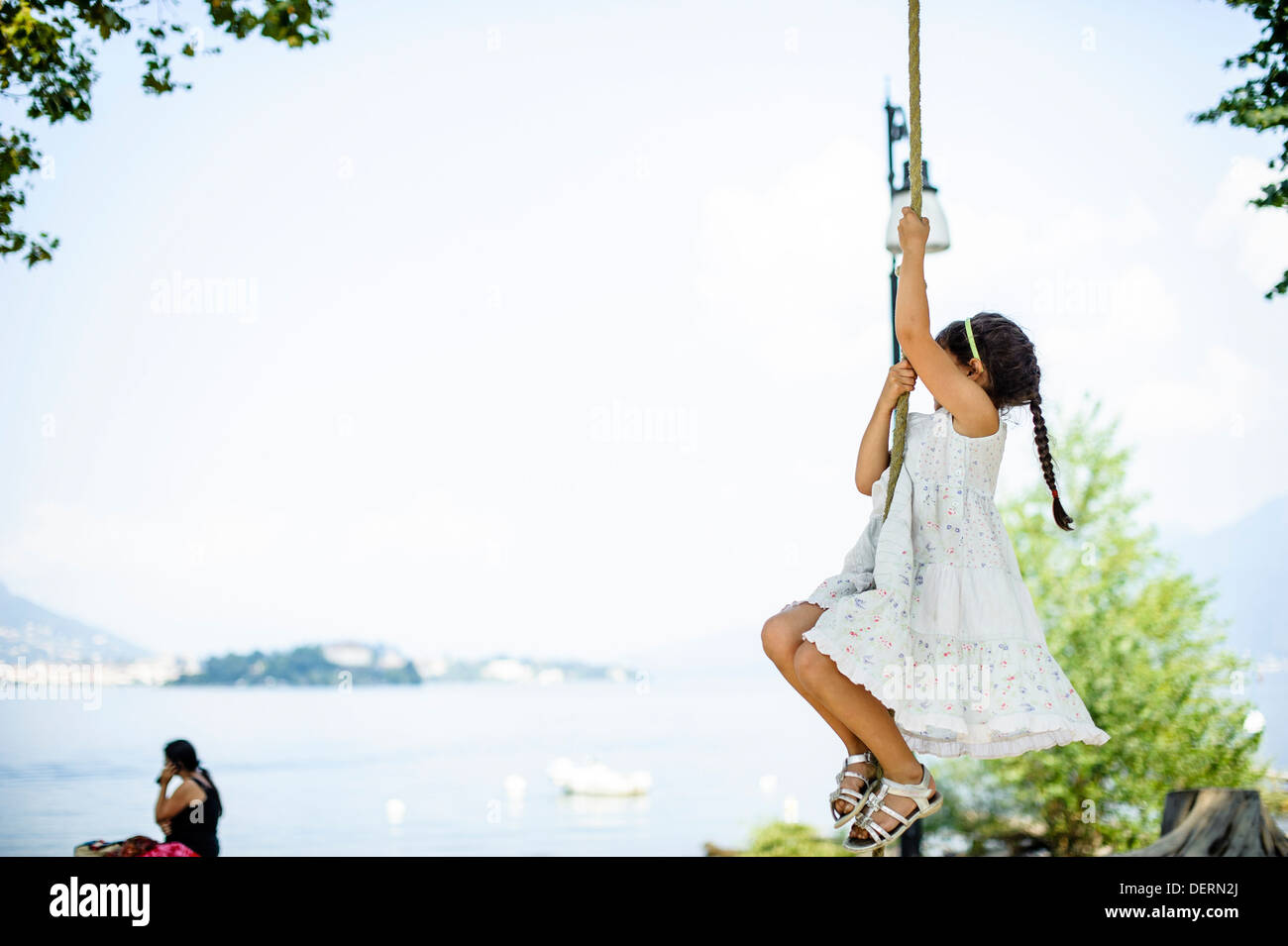 little girl climbs on a rope Stock Photo - Alamy