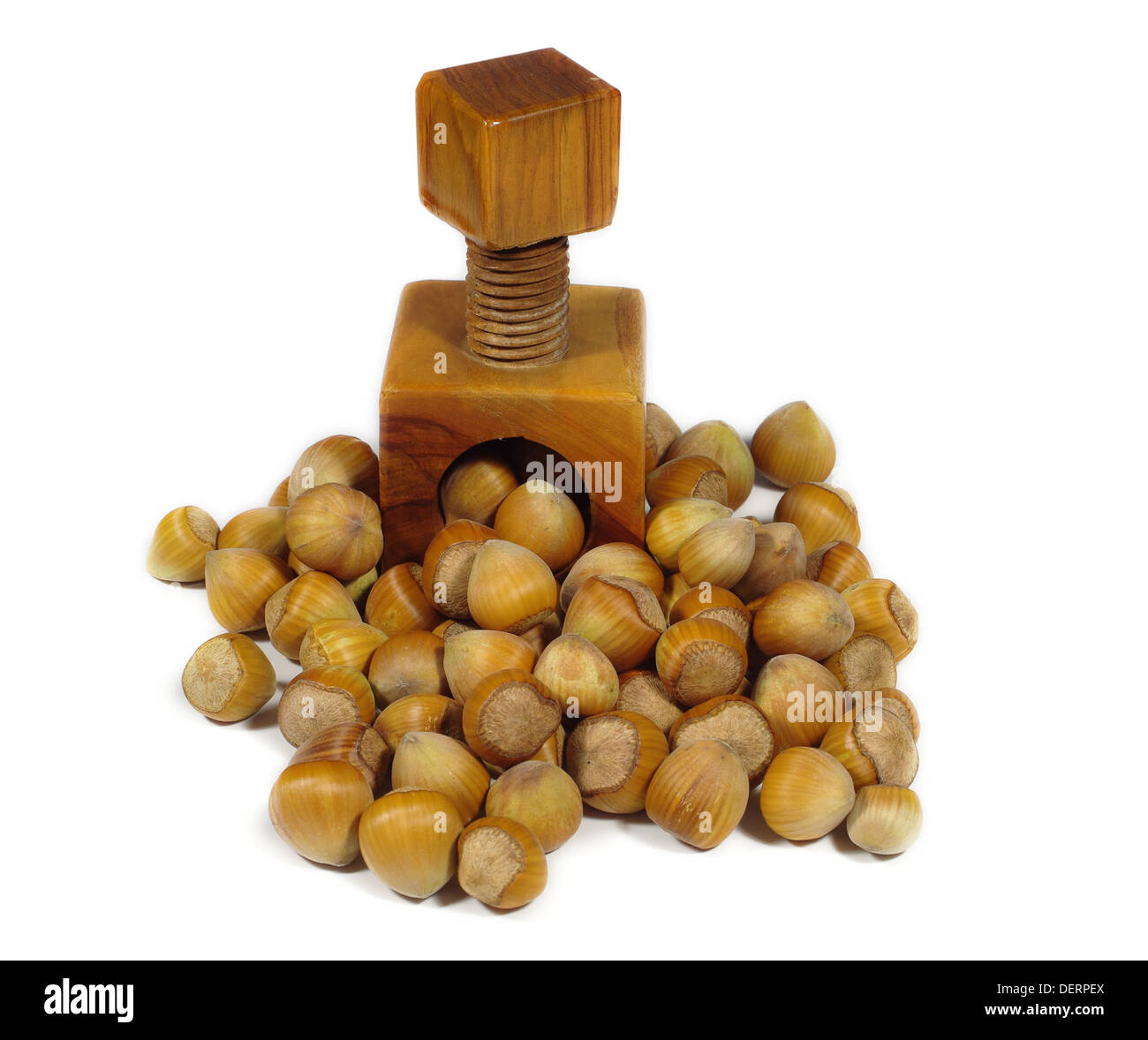 hazelnuts and wooden nutcracker on white background Stock Photo - Alamy