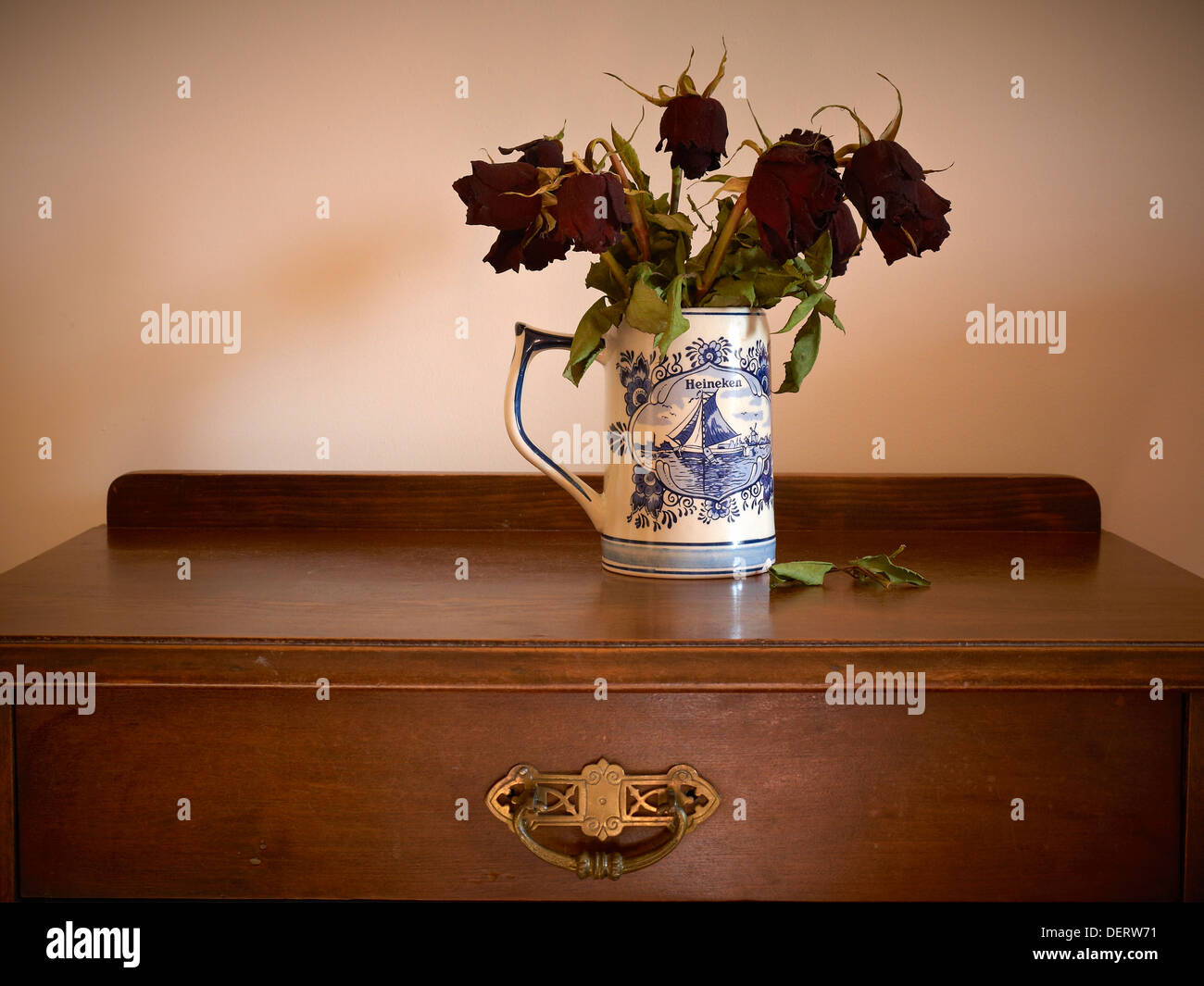 Roses in Heineken beer mug Stock Photo - Alamy
