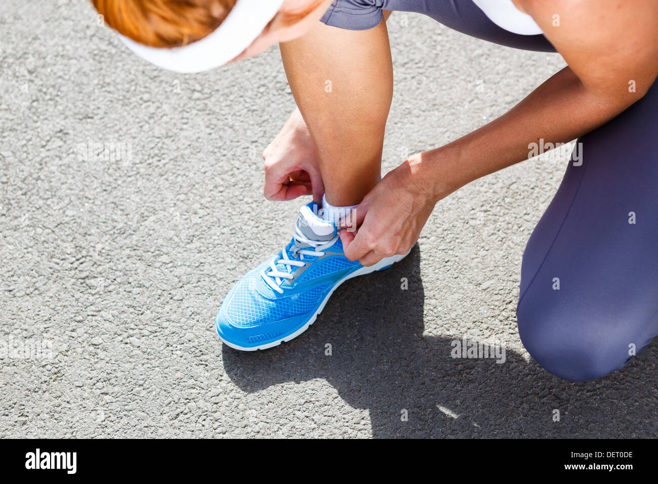 Female athlete tying shoelace hi-res stock photography and images - Alamy