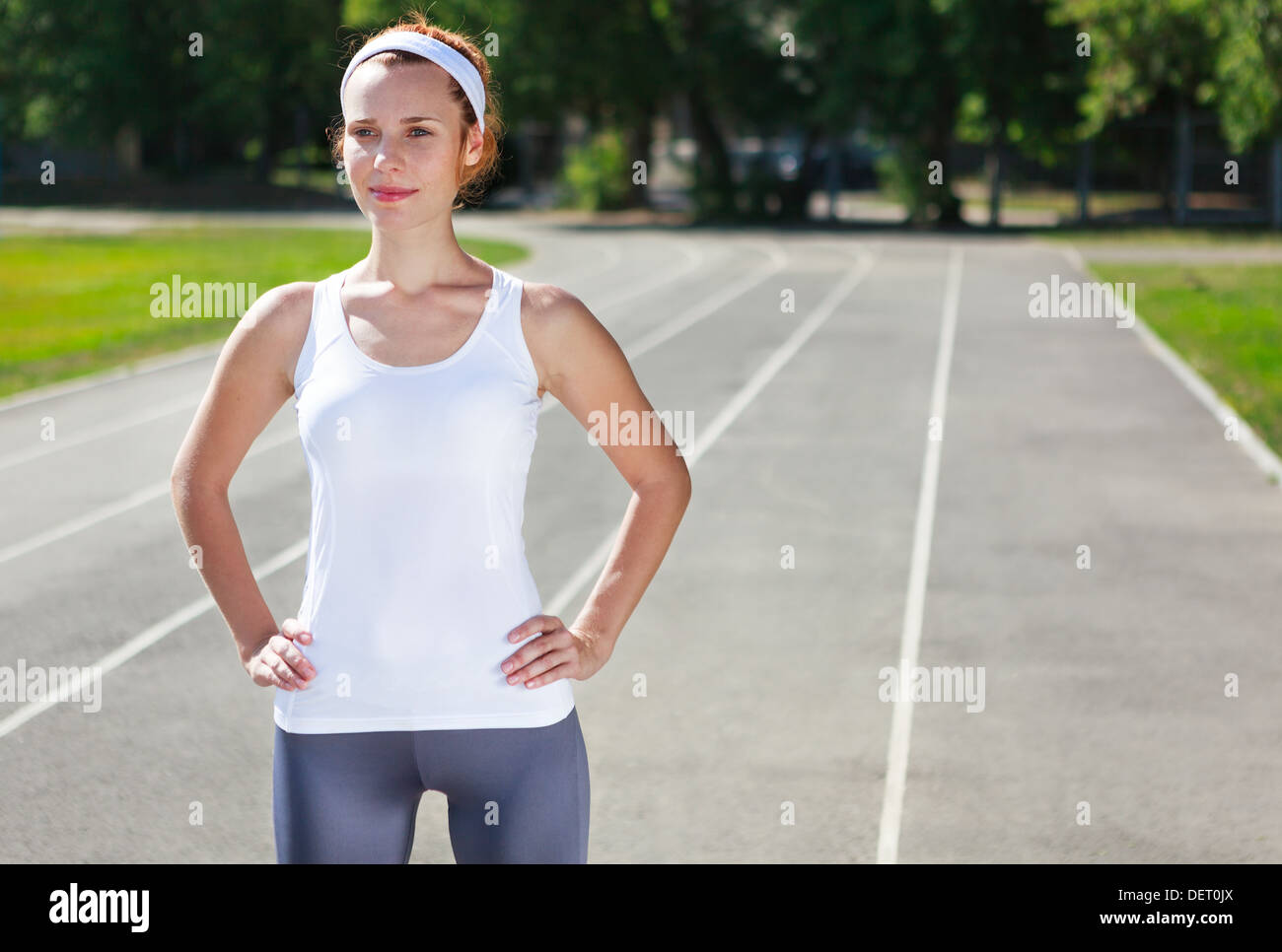 Young woman on stadium preparing herself for marathon run Stock Photo ...