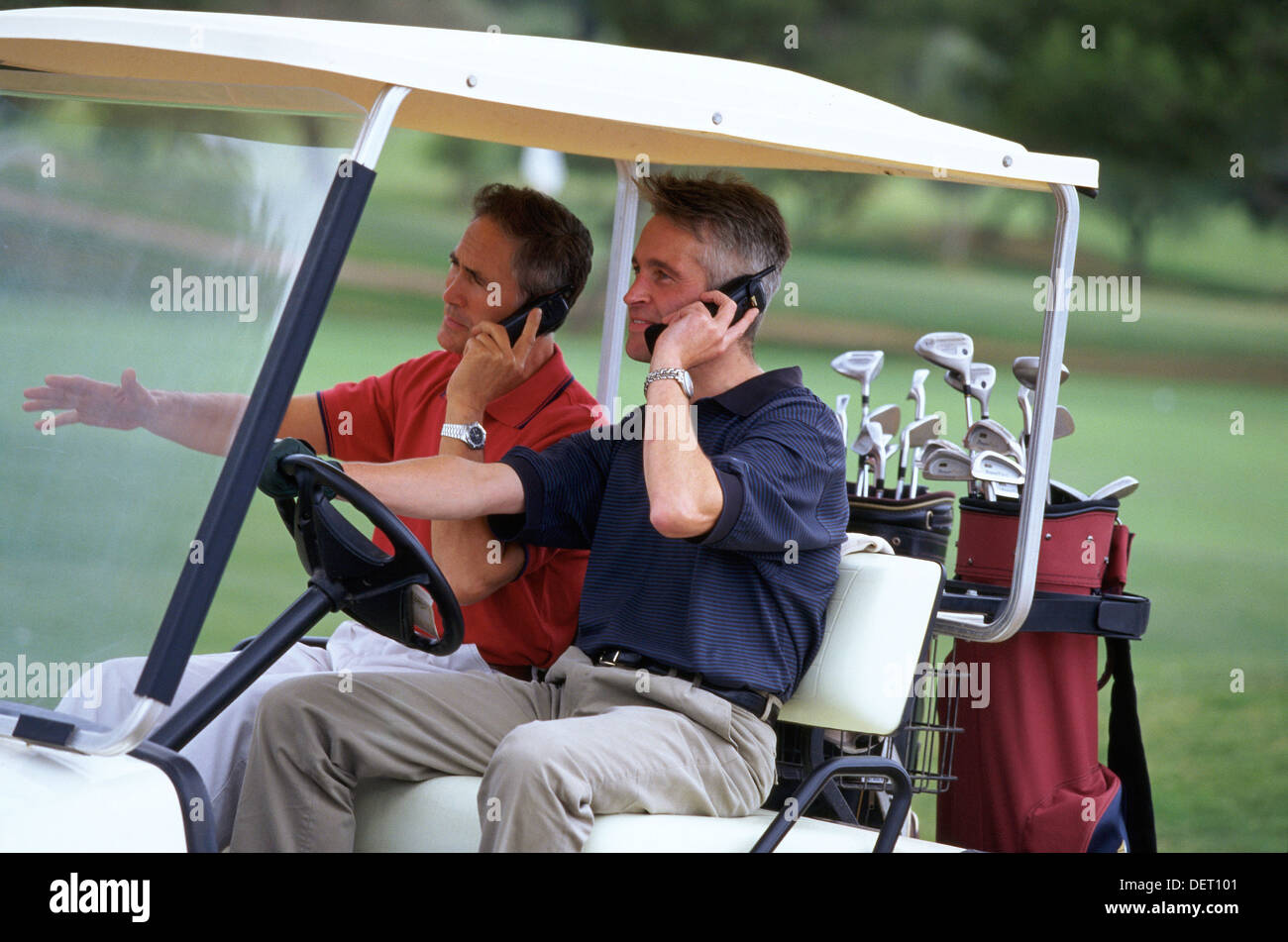 Two men driving golf cart hi-res stock photography and images - Alamy