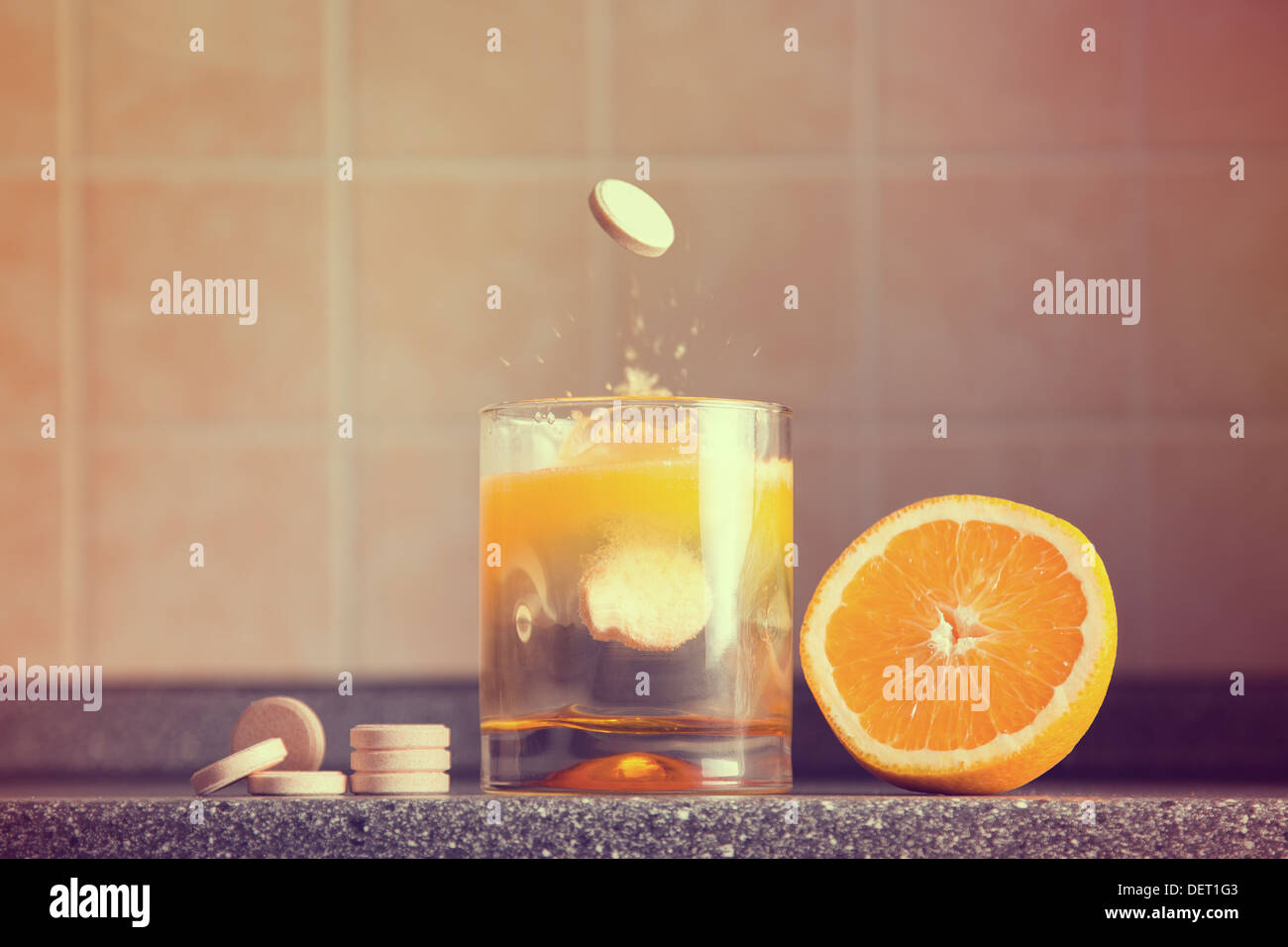 Artistic shot of vitamin C family, orange, tablet stack, dissolving ...