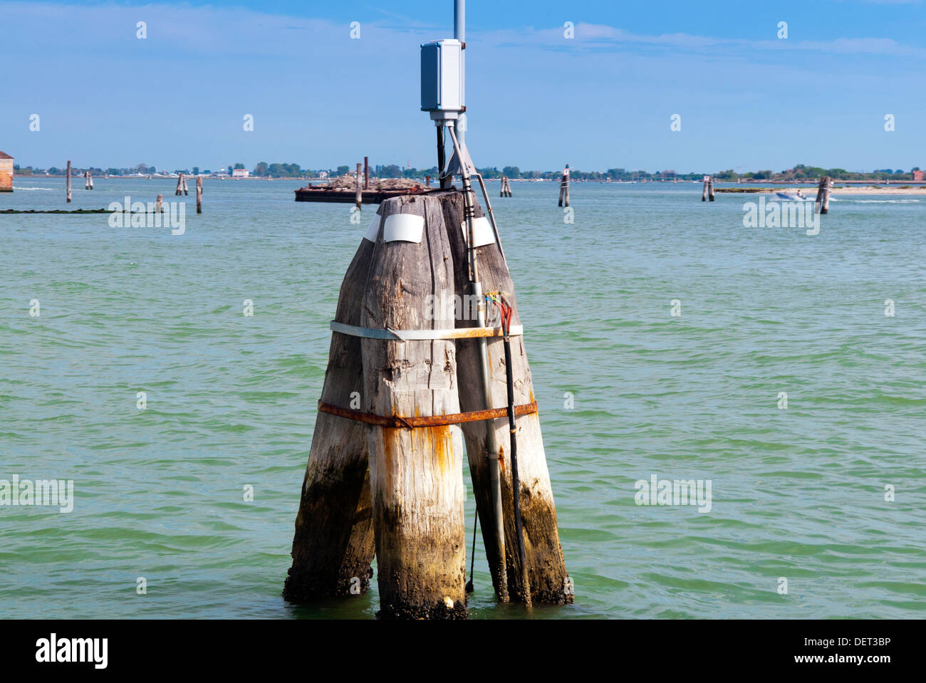 Bricole, wooden poles that mark the waterways, Venetian lagoon, Venice ...