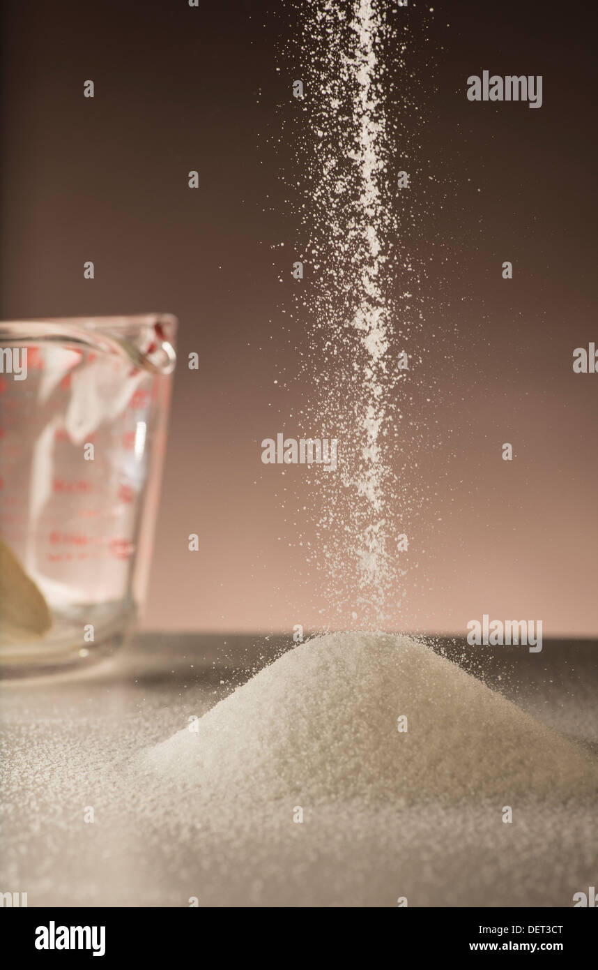 Bakery Kitchen Counter With Sugar Pouring In To Pile Stock Photo - Alamy