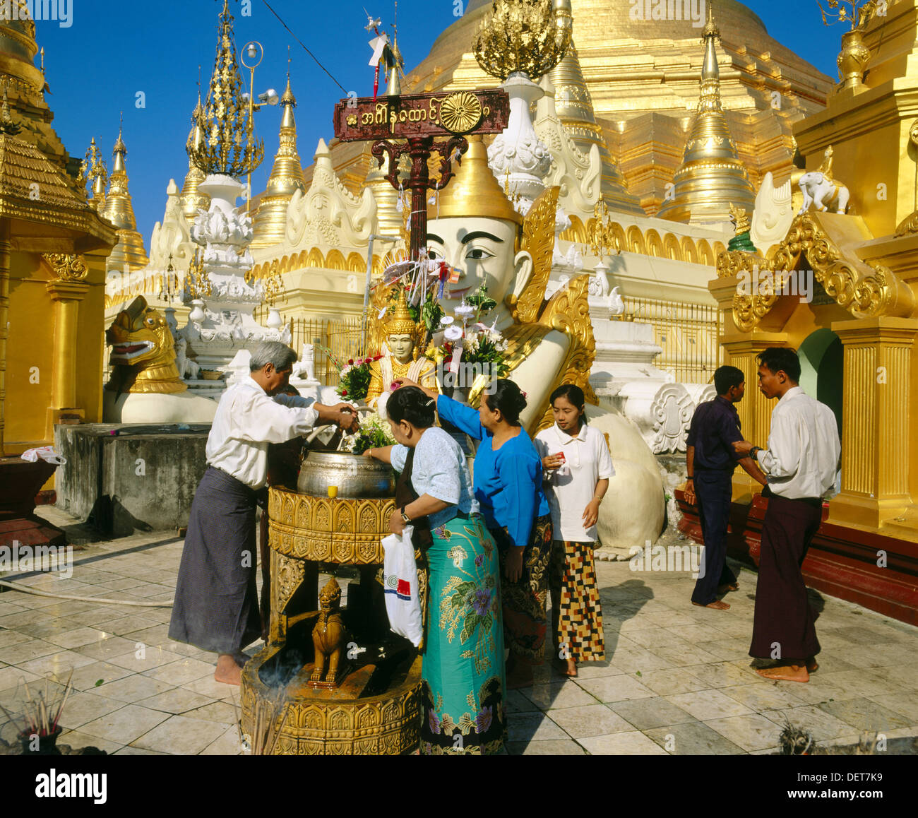 People doing a bouddhist ritual in the Shwedagon Pagoda. Yangoon ...