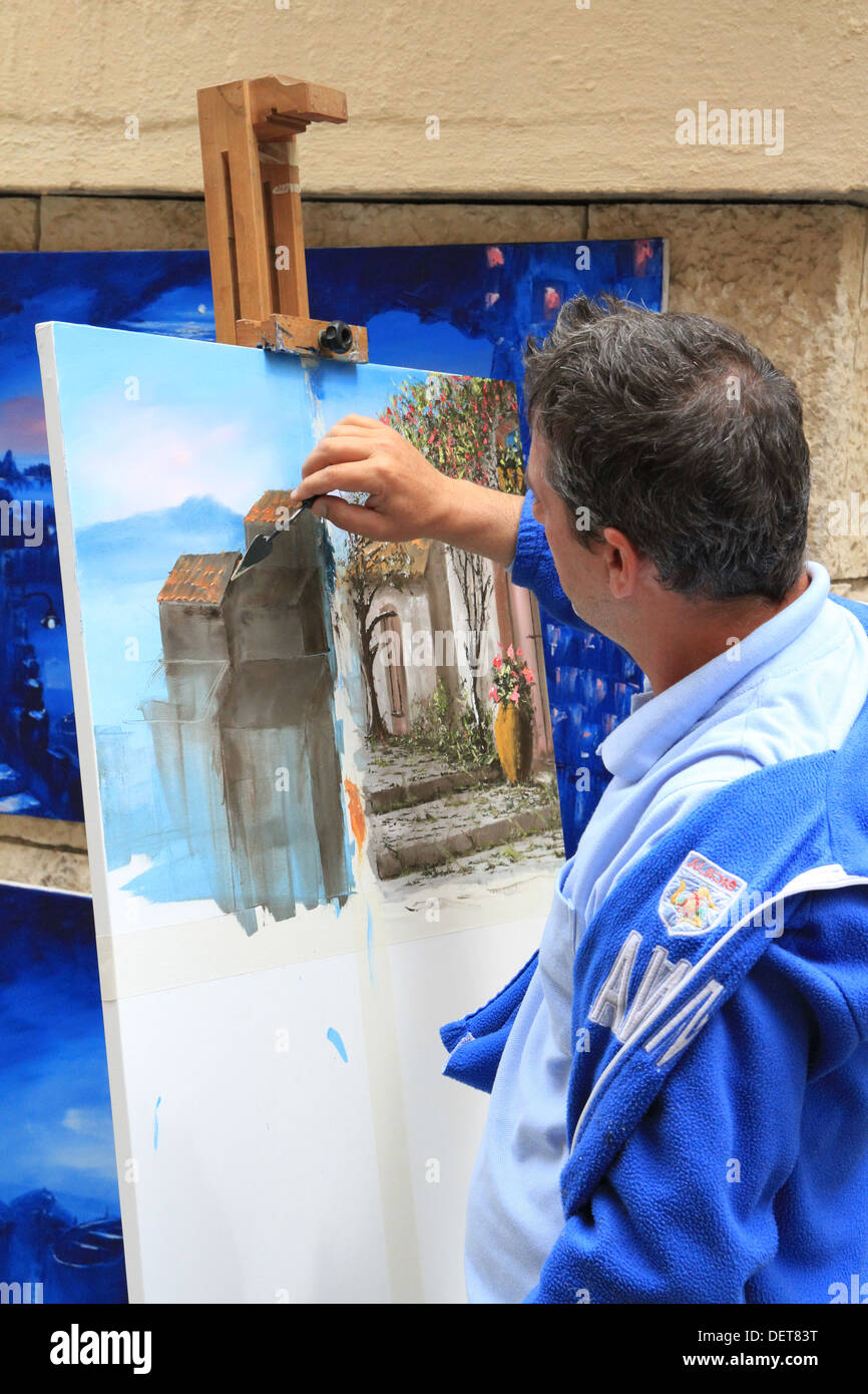 Colourful artists paint and sketch in the main Piazza square in ...