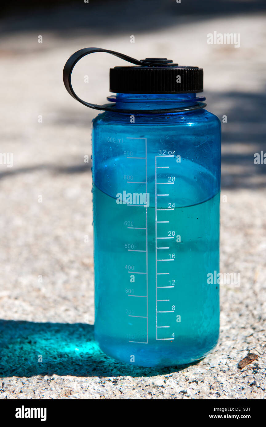 Blue hiking water bottle on a rock Stock Photo - Alamy