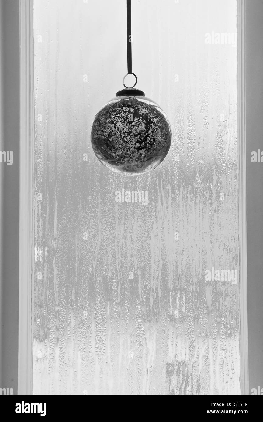 A Christmas bauble with a condensation covered window Stock Photo - Alamy