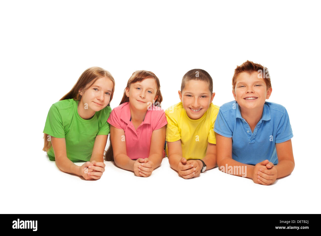 Group of happy boys and girls laying in a row isolated on white Stock ...