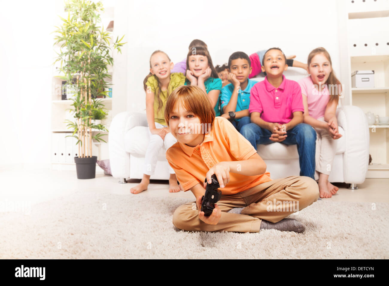 Happy 10 years old boy playing video games holding game controller ...