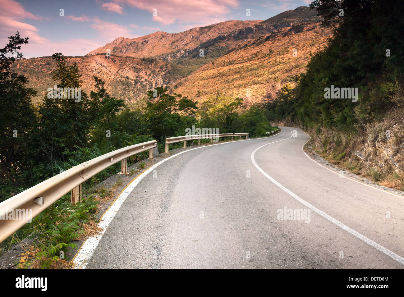 Montenegro, curved mountain highway in soft early morning sun light ...