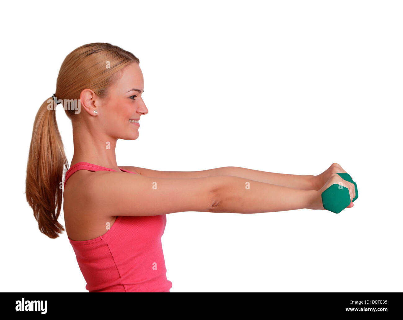 Profile of a young blonde woman doing exercise with dumbbells isolated ...