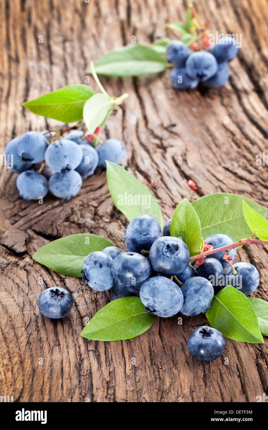 Blueberries with leaves on a wooden table. Studio isolated Stock Photo ...