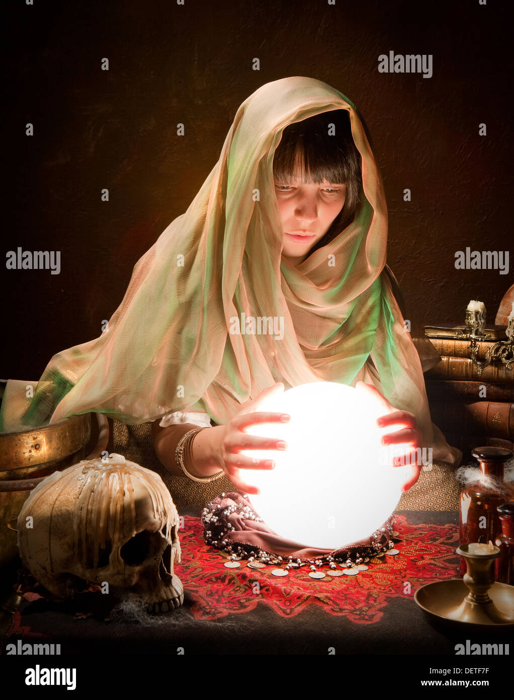 Young fortune-teller reading the future in a crystral ball Stock Photo ...