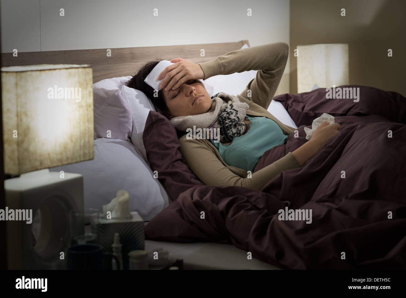 Young Caucasian woman lying sick in bed suffering from cold Stock Photo ...