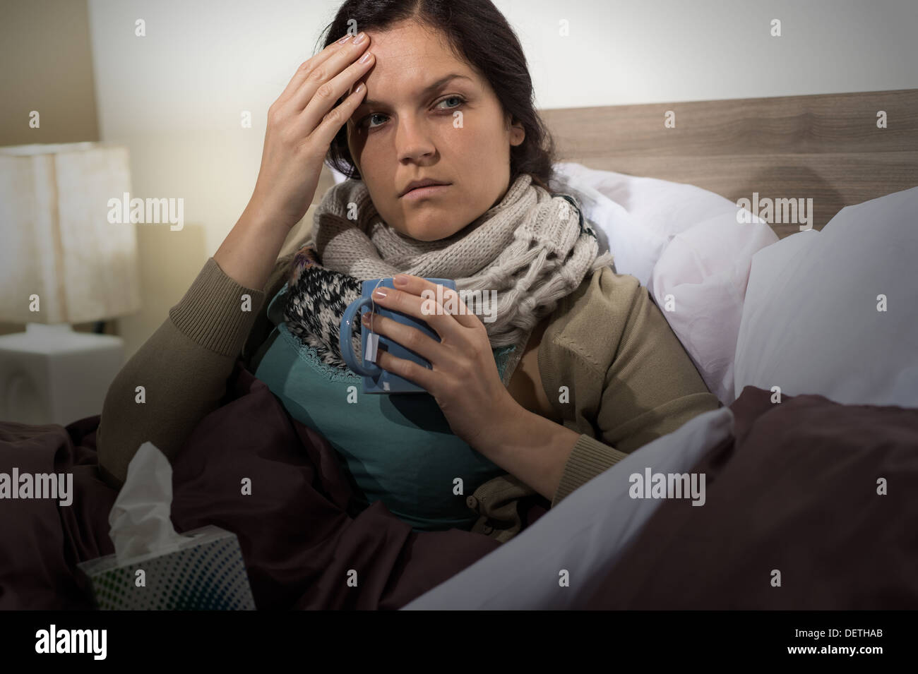 Young woman having flu sitting in bed Stock Photo - Alamy